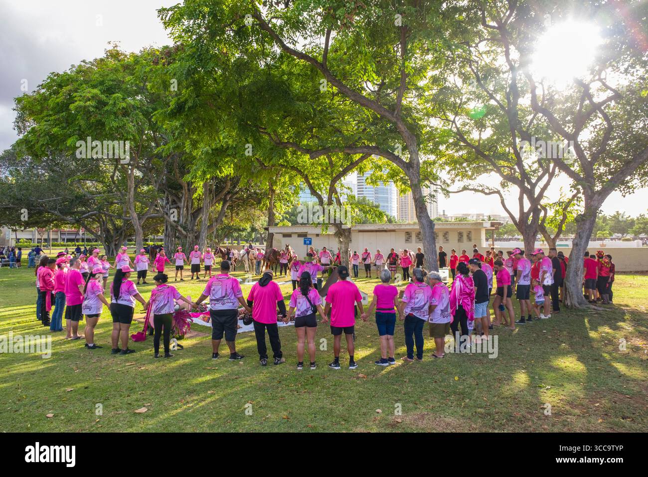 Large circle of people holding hands and praying before the start of ...