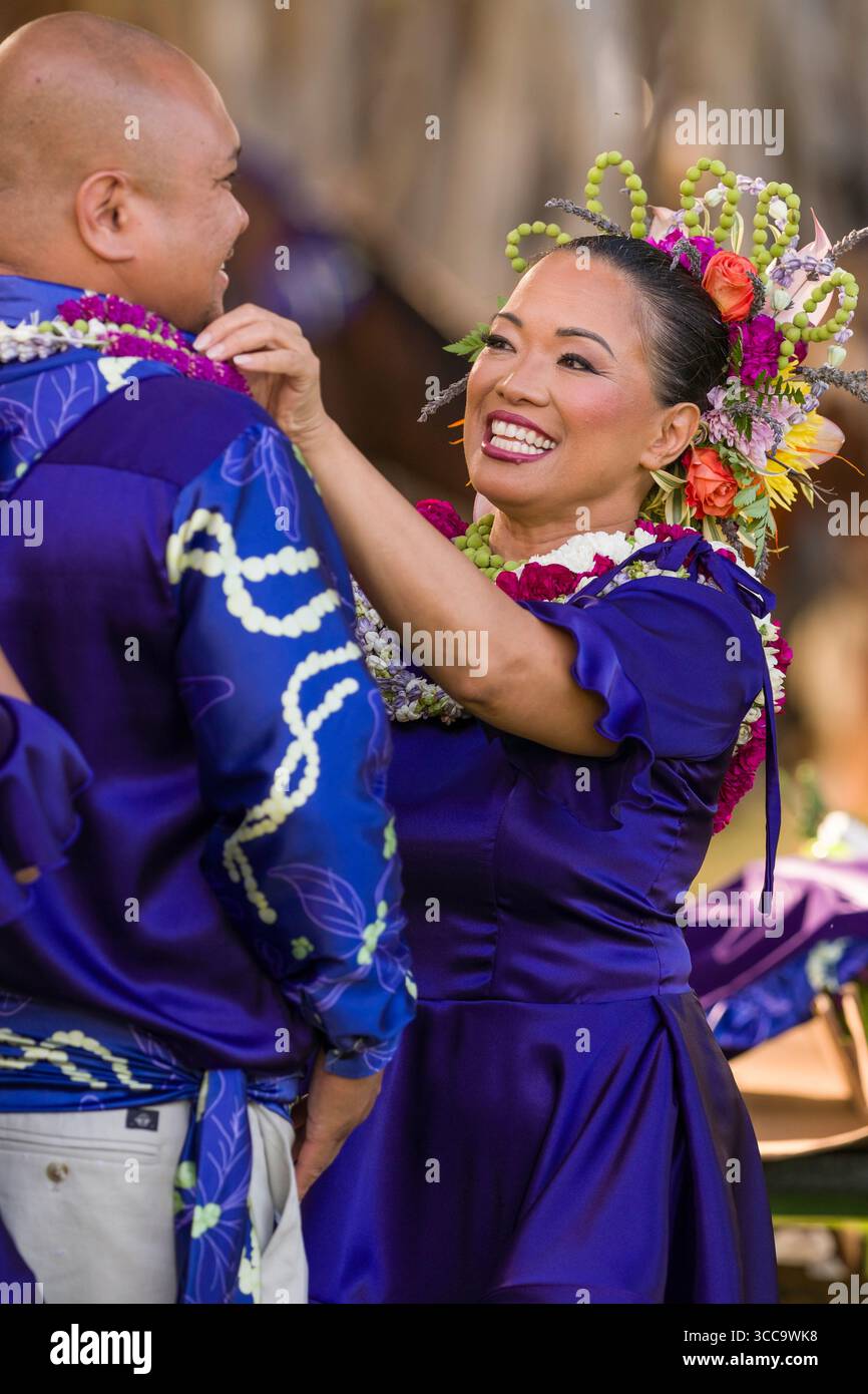 Female Pa’u riders tying and adjusting lei on male Pa’u rider before the start of the Aloha ...