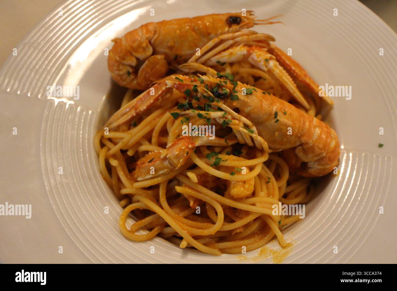 Italian cuisine: spaghetti alla busara (spaghetti with scampi and ...