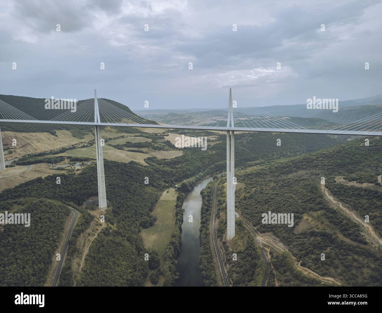 Aerial view of the Viaduc de Millau stretching across a valley with a ...