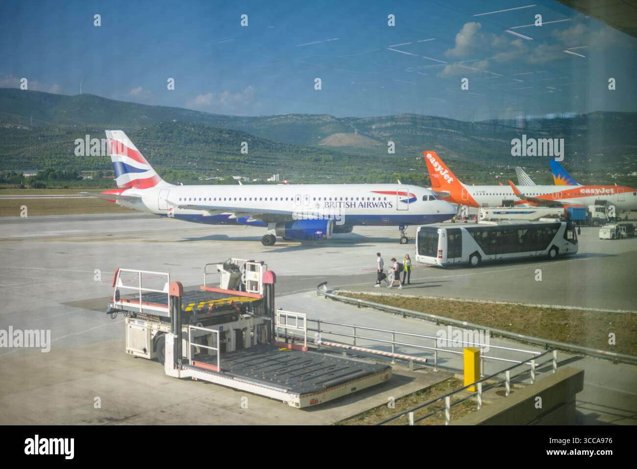 Through the glass window view of Split international airport runway in ...