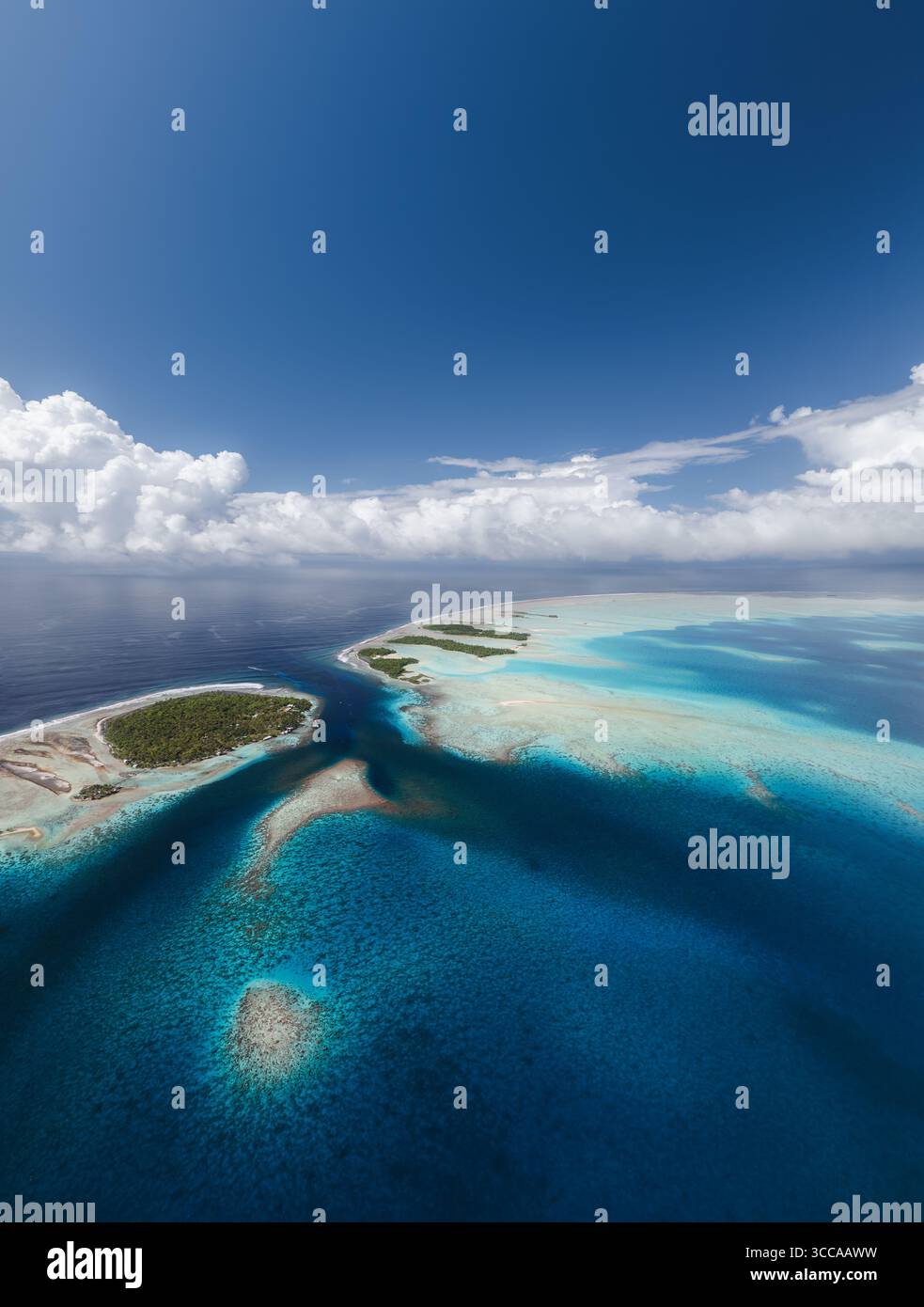 Aerial view of a turquoise lagoon embracing small islands under a vast ...