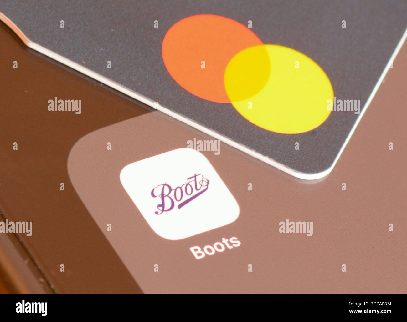 Boots app on smartphone screen with a Mastercard to pay for the ...