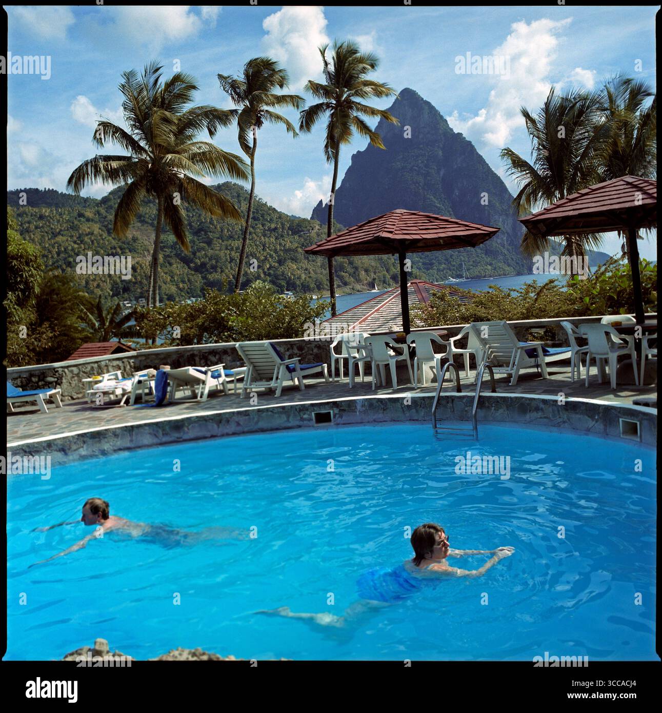 View of the Pitons overlooking a awimming pool on St. Lucia Stock Photo ...