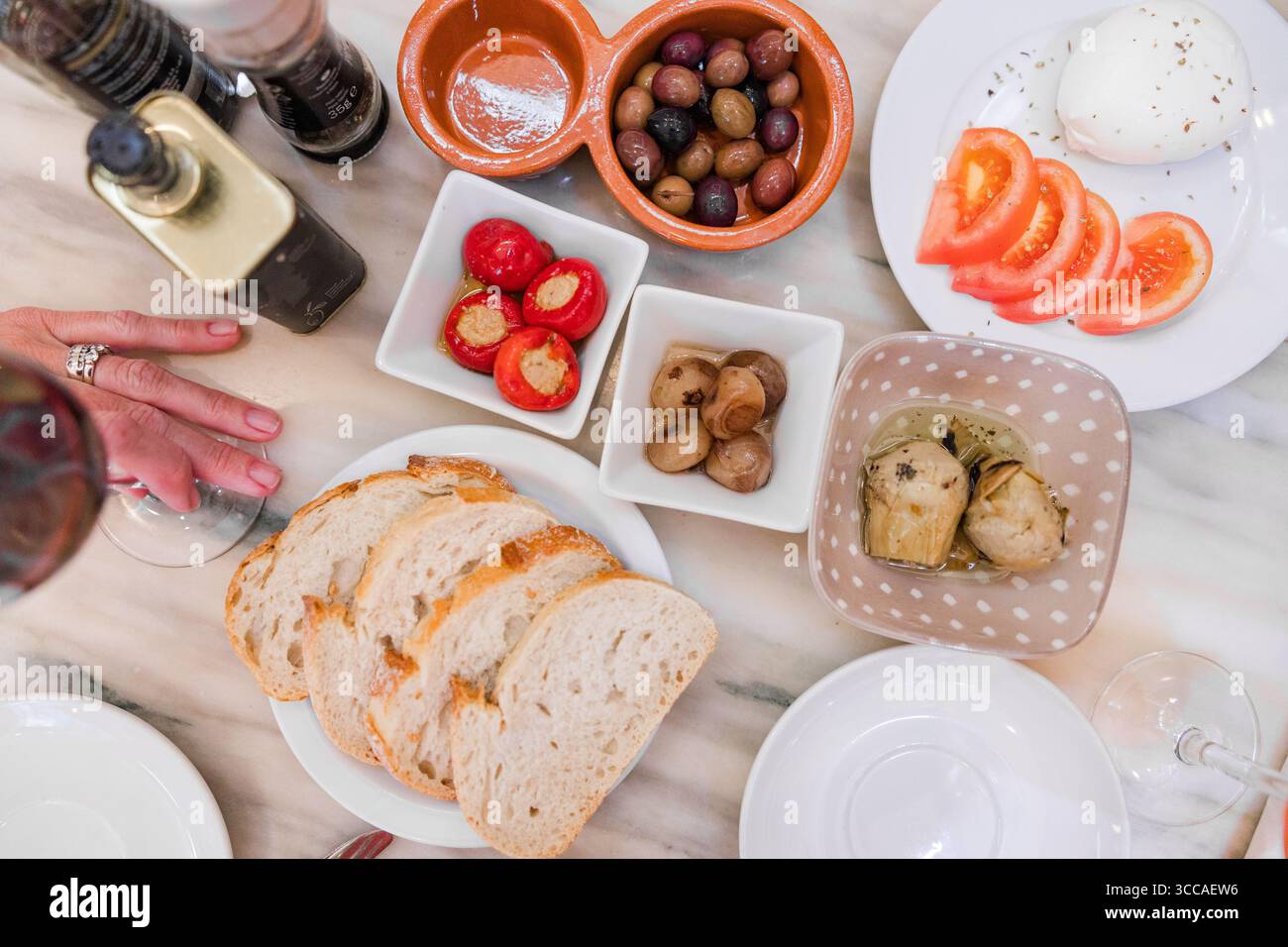 Assorted Mediterranean appetizers with bread, cheese, and vegetables ...