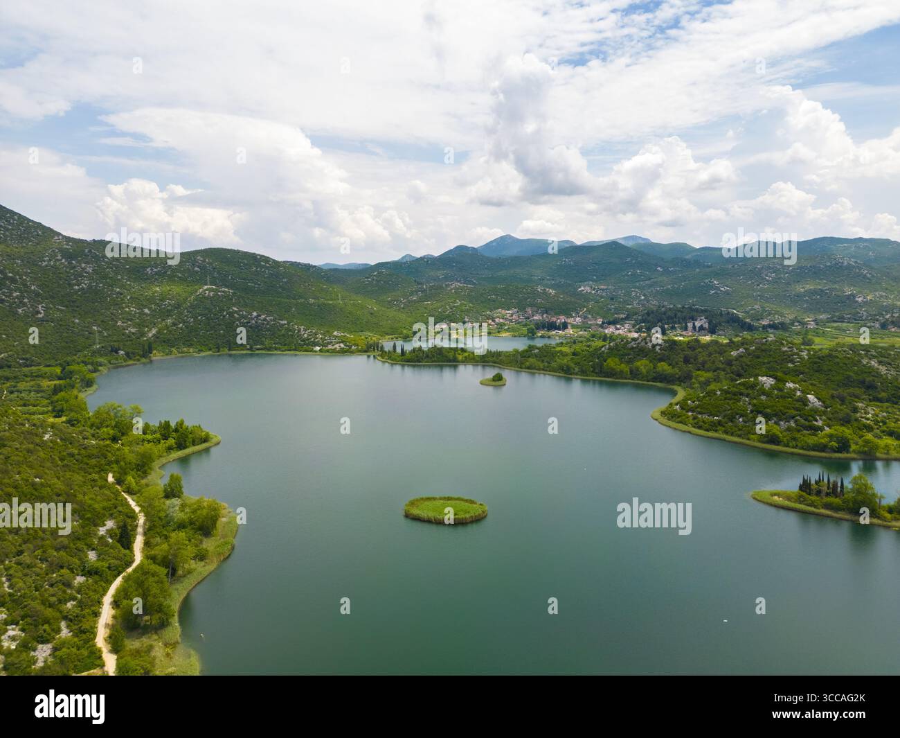 Aerial view of serene Bacina Lakes mirroring the sky, embraced by lush ...