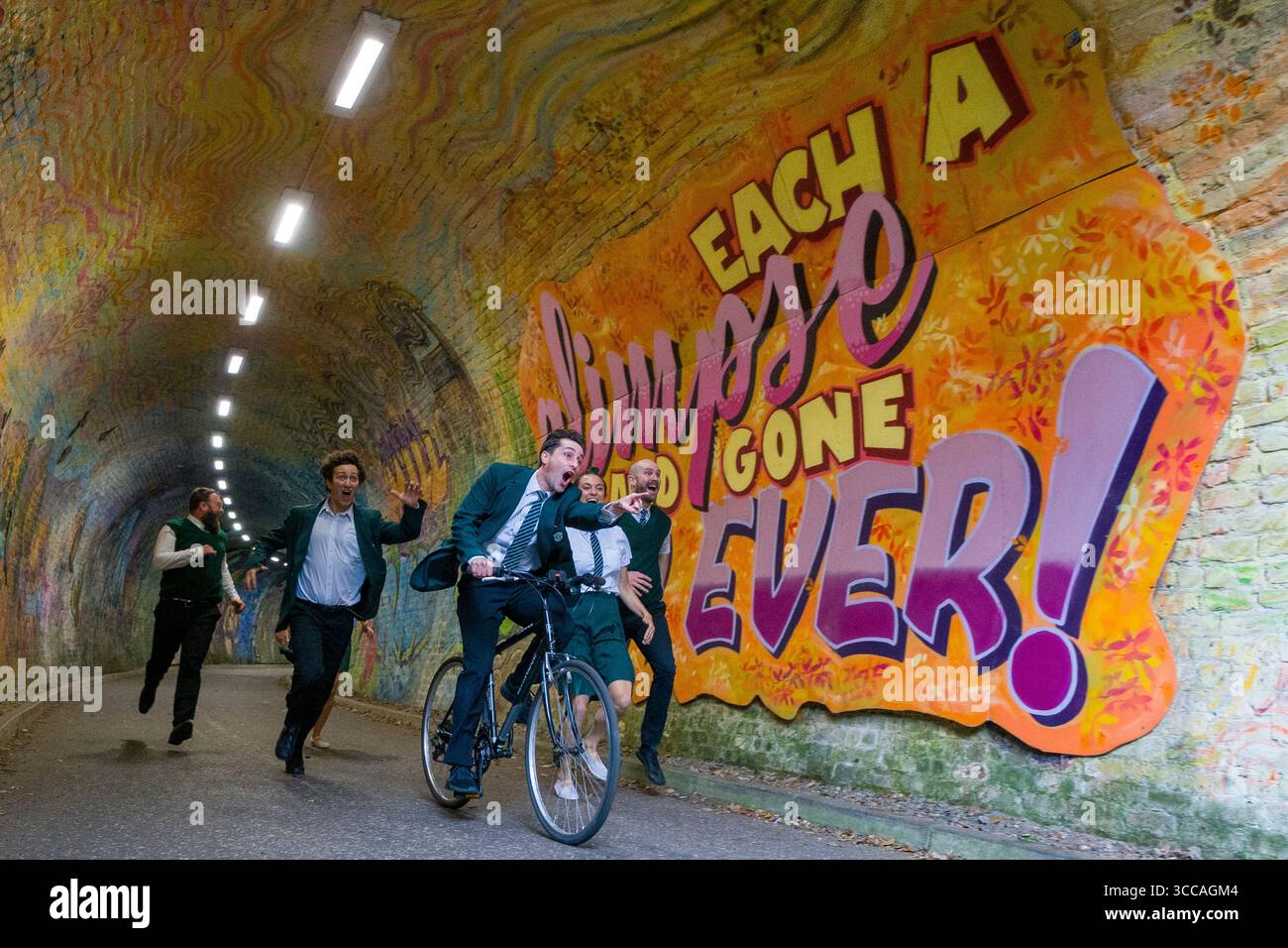 Members of the Theatre Re ensemble cycling and running through the ...