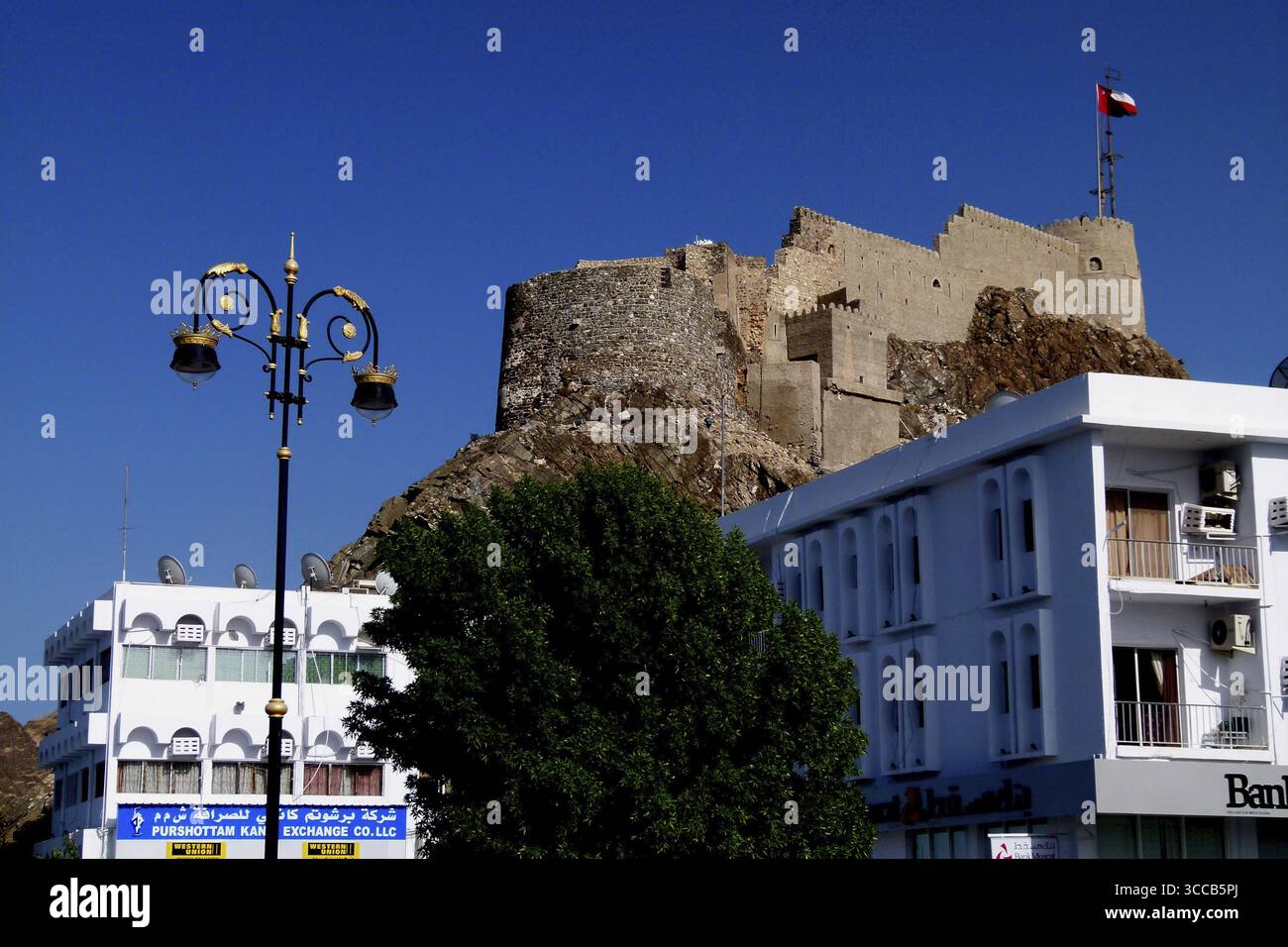 Fort Jalali towers over the houses of Muscat, Oman Stock Photo - Alamy