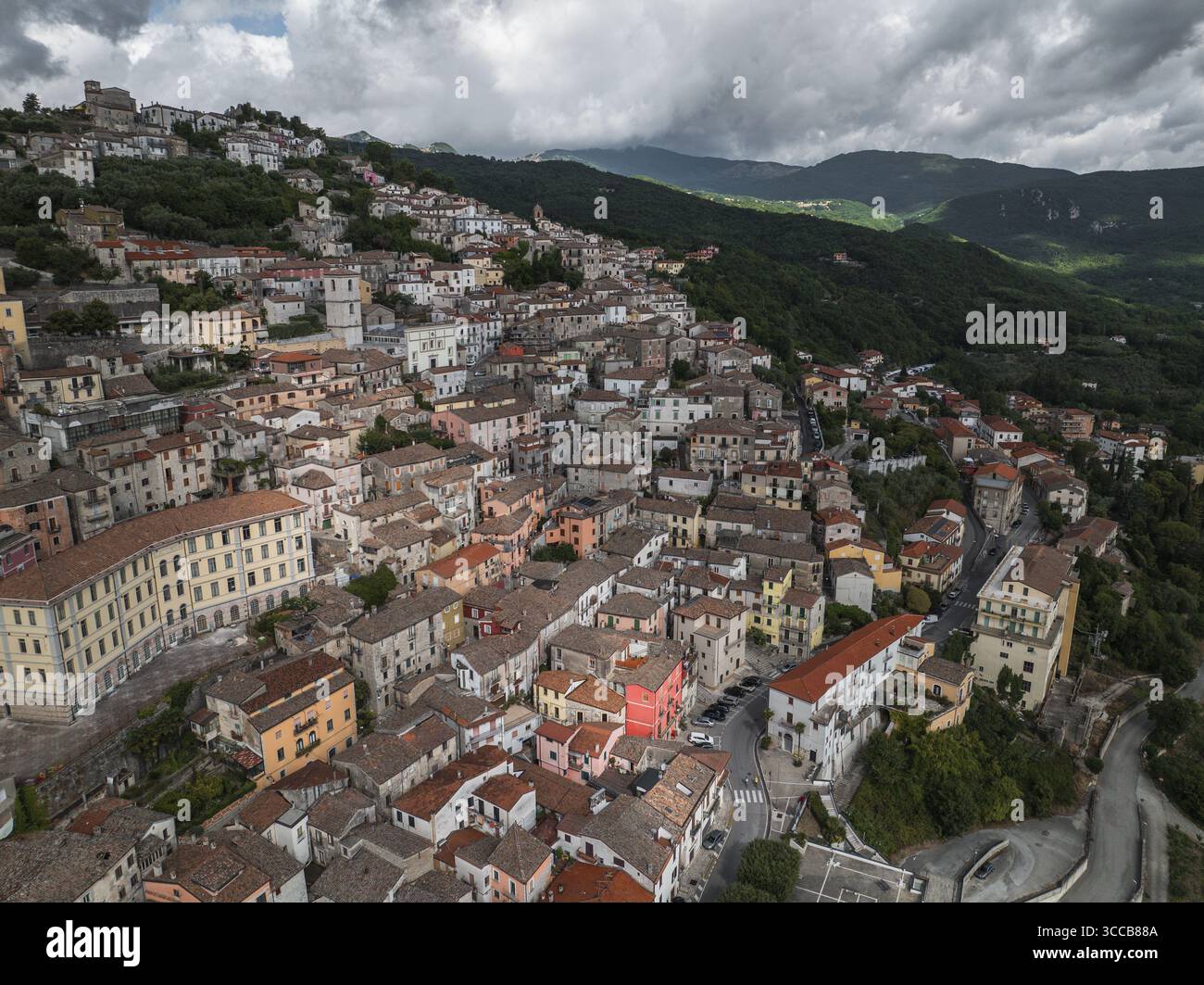 Aerial hillside cityscape under dramatic hi-res stock photography and ...