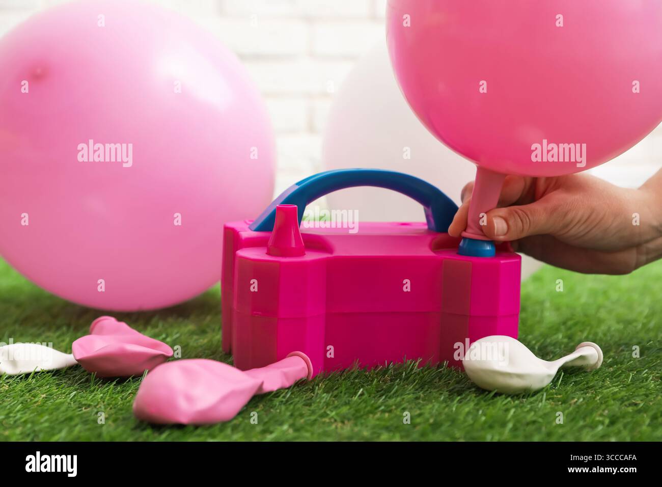 Woman inflating balloon with air pump indoors, closeup Stock Photo - Alamy