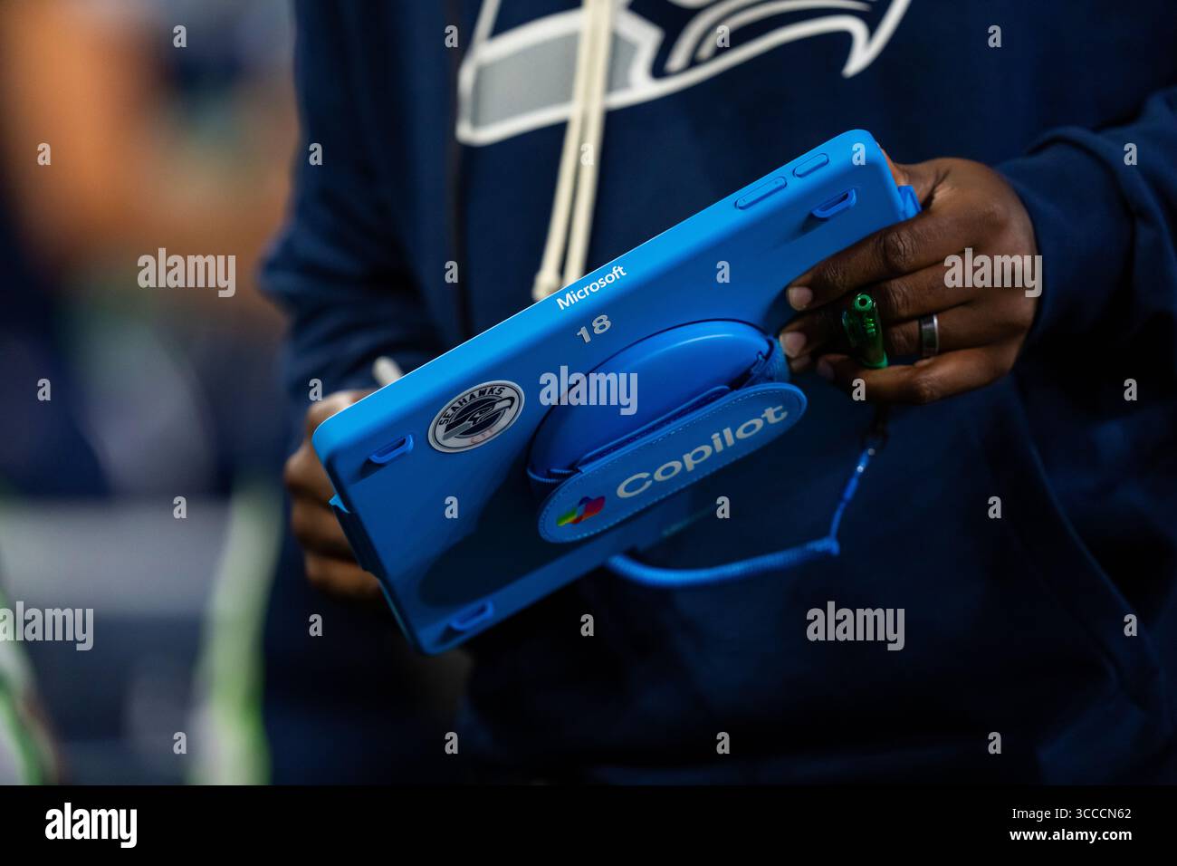 A Seattle Seahawks coach holds a Microsoft Surface tablet during an NFL ...