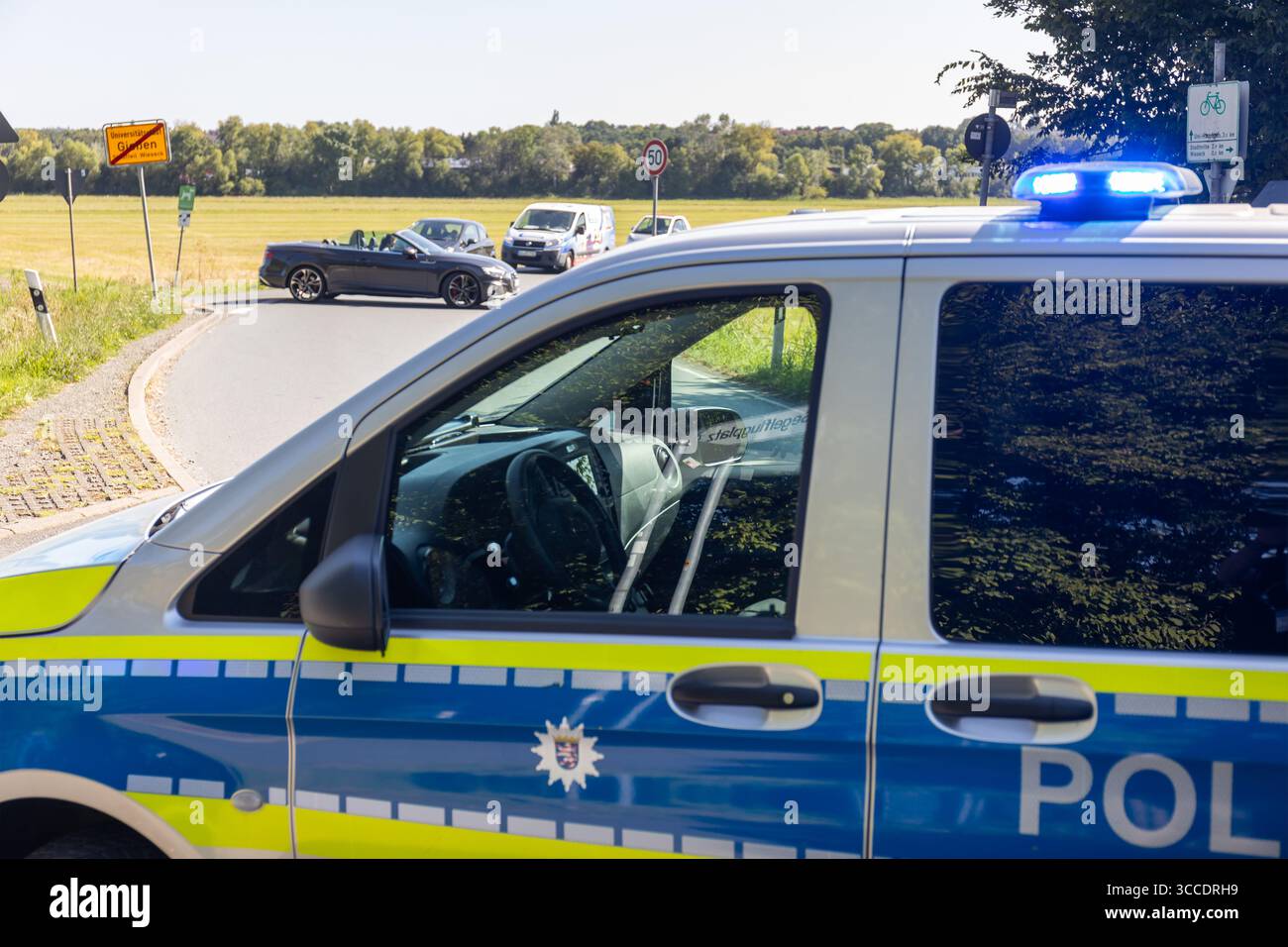 11 August 2025, Hesse, Gießen: The police close a road to Wieseck after ...