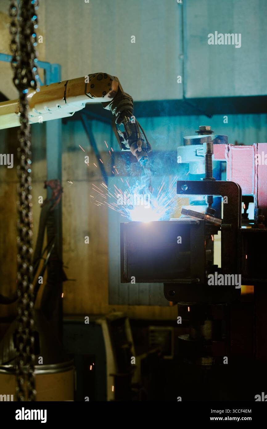 Industrial Robotic Arm Performing Automated Welding Process in Factory ...
