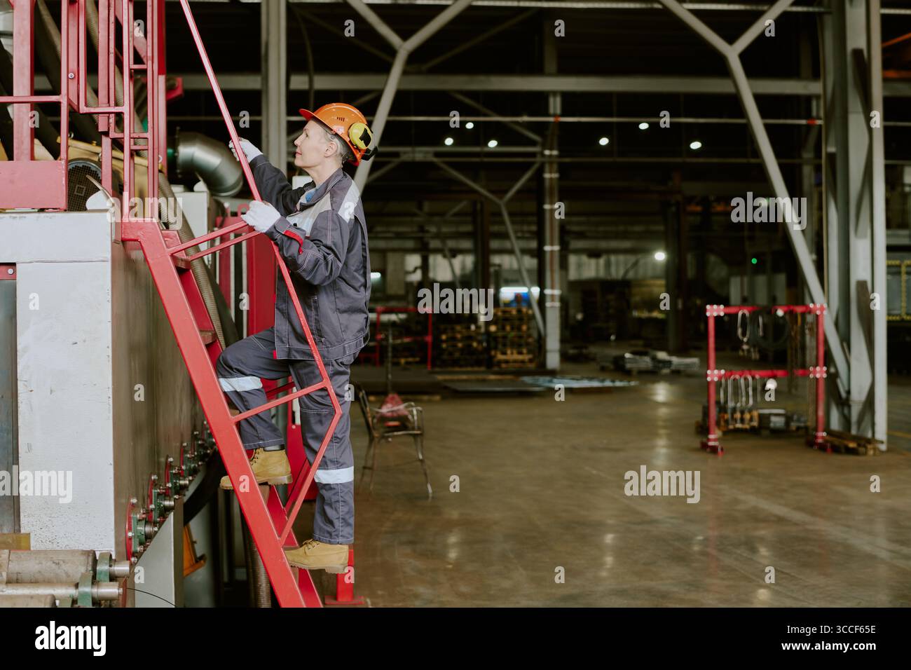Woman Wearing Helmet Climbing Industrial Ladder at Factory Stock Photo ...