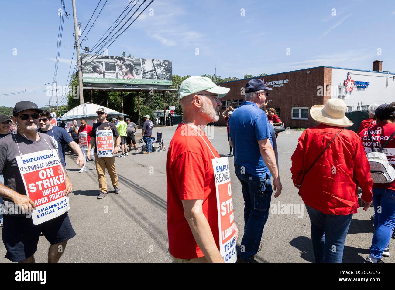 August 8, 2025. Peabody, MA. Striking waste management workers walk the ...