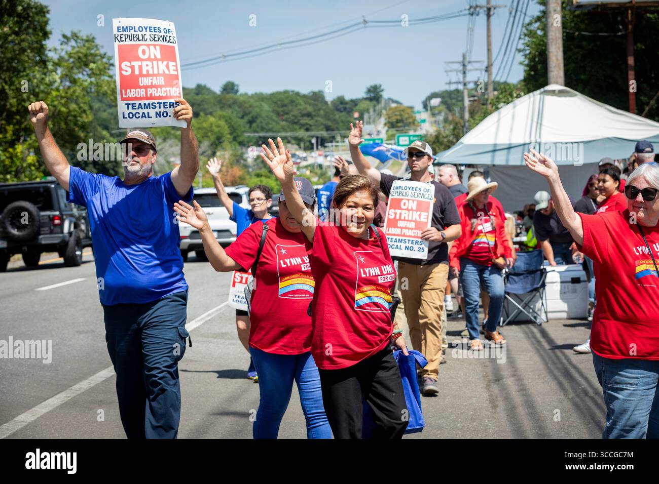 August 8, 2025. Peabody, MA. Striking waste management workers walk the ...