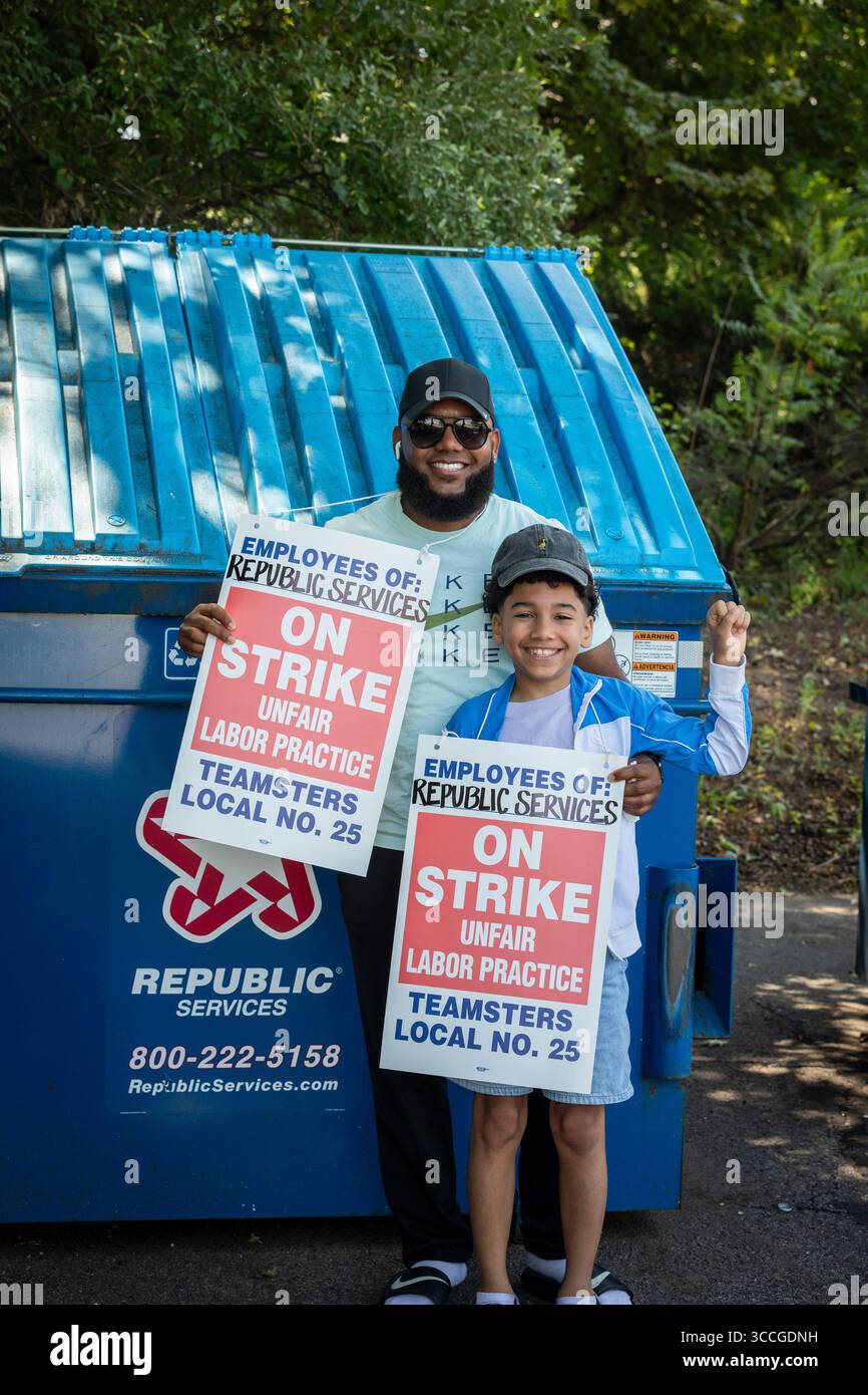 August 8, 2025. Peabody, MA. Striking waste management workers walk the ...