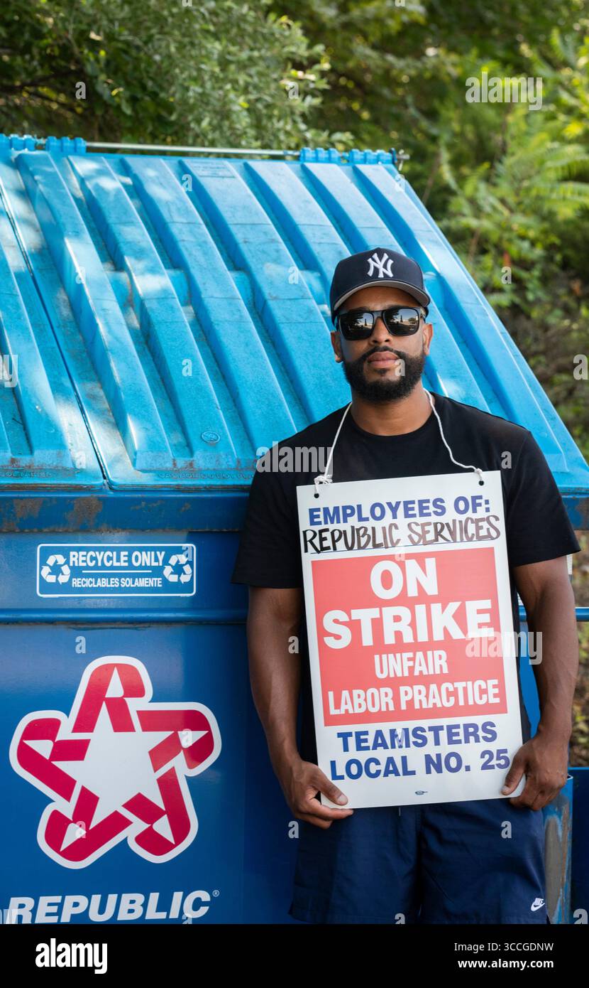 August 8, 2025. Peabody, MA. Striking waste management workers walk the ...