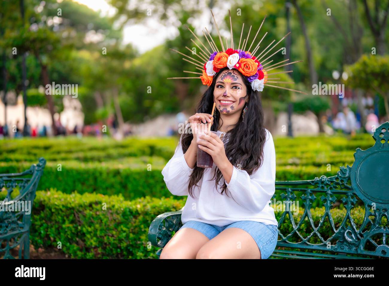 Young Latina woman with catrina makeup and colorful flower crown smiles ...