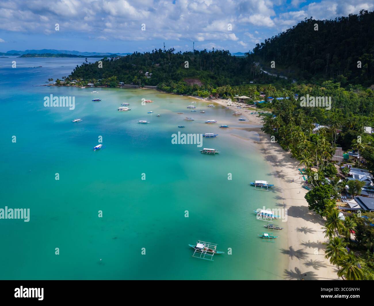 Port Barton beach with many traditional Filipino boats on the coastline ...