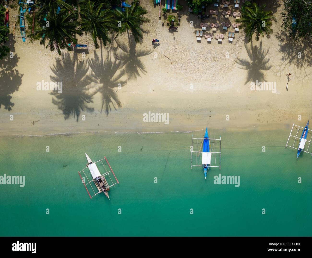 Port Barton beach with many traditional Filipino boats on the coastline ...