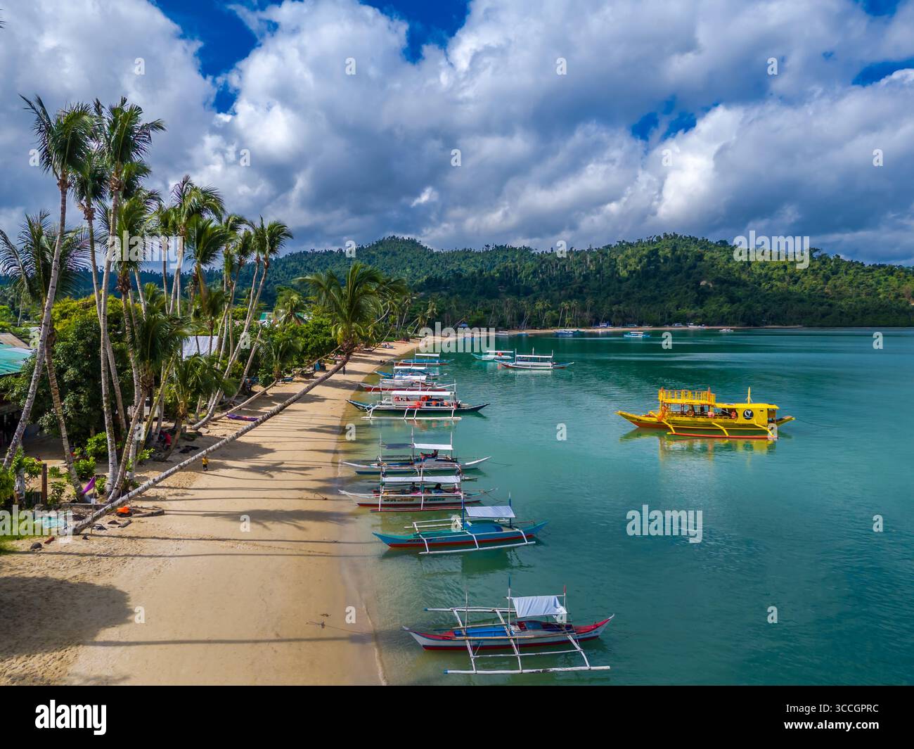 Port Barton beach with many traditional Filipino boats on the coastline ...