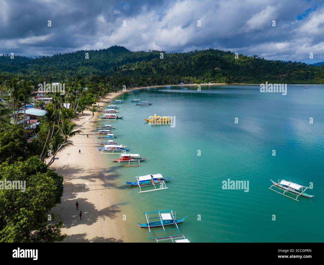 Port Barton beach with many traditional Filipino boats on the coastline ...