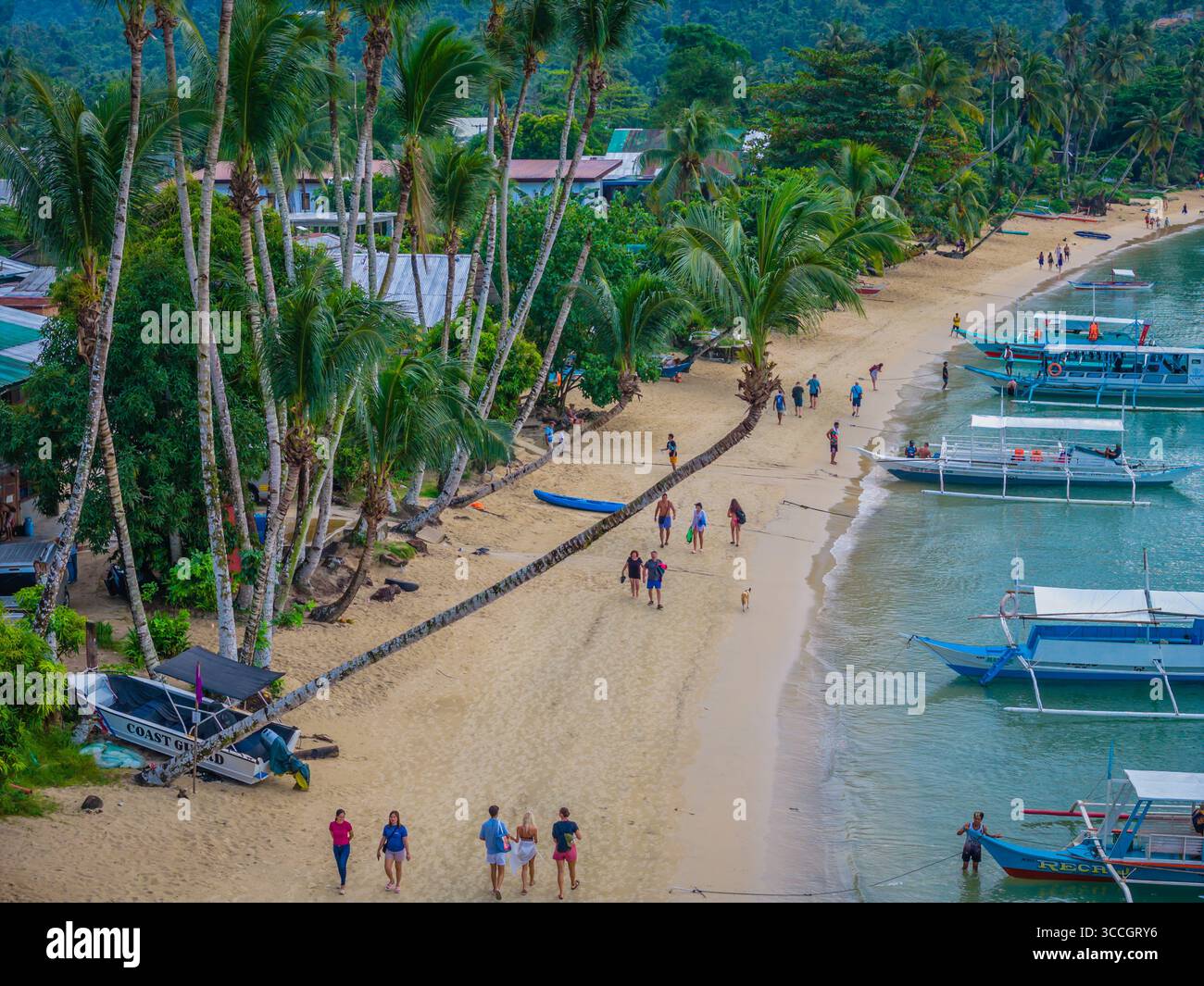 Port Barton beach with many traditional Filipino boats on the coastline ...
