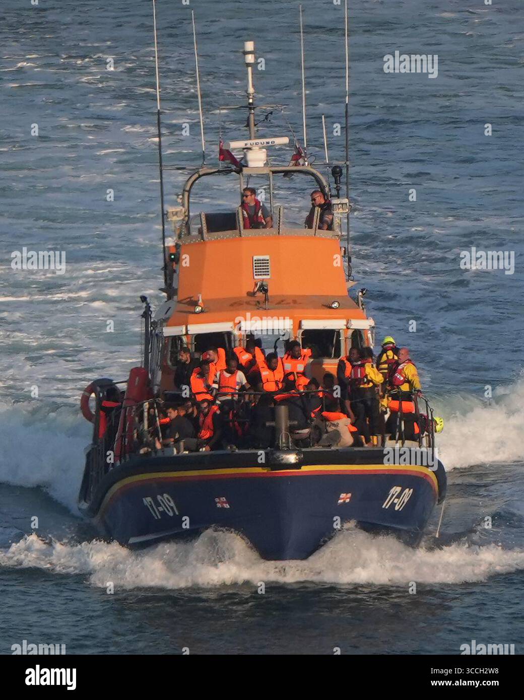 A group of people thought to be migrants are brought in to the Border ...