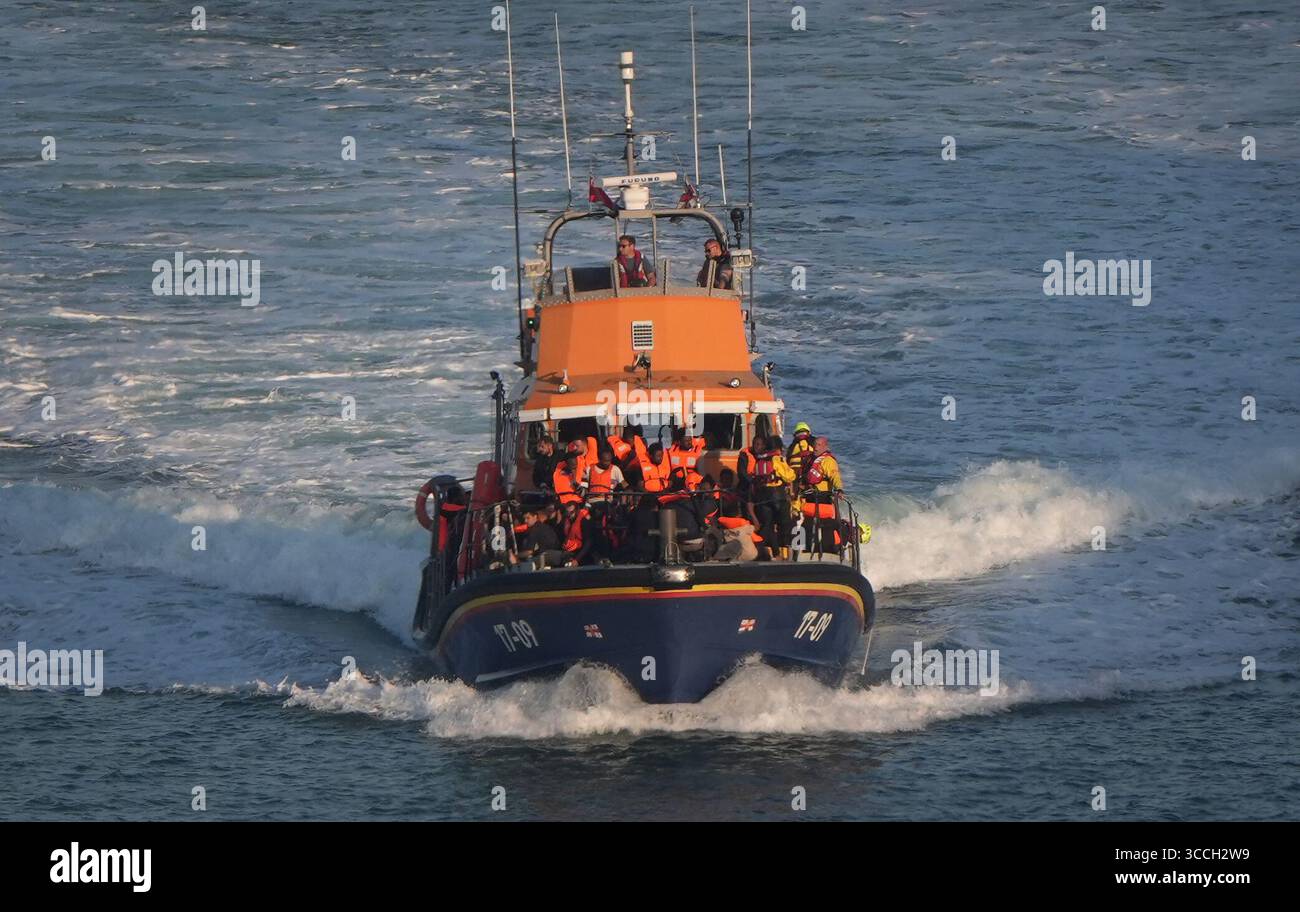 A group of people thought to be migrants are brought in to the Border ...