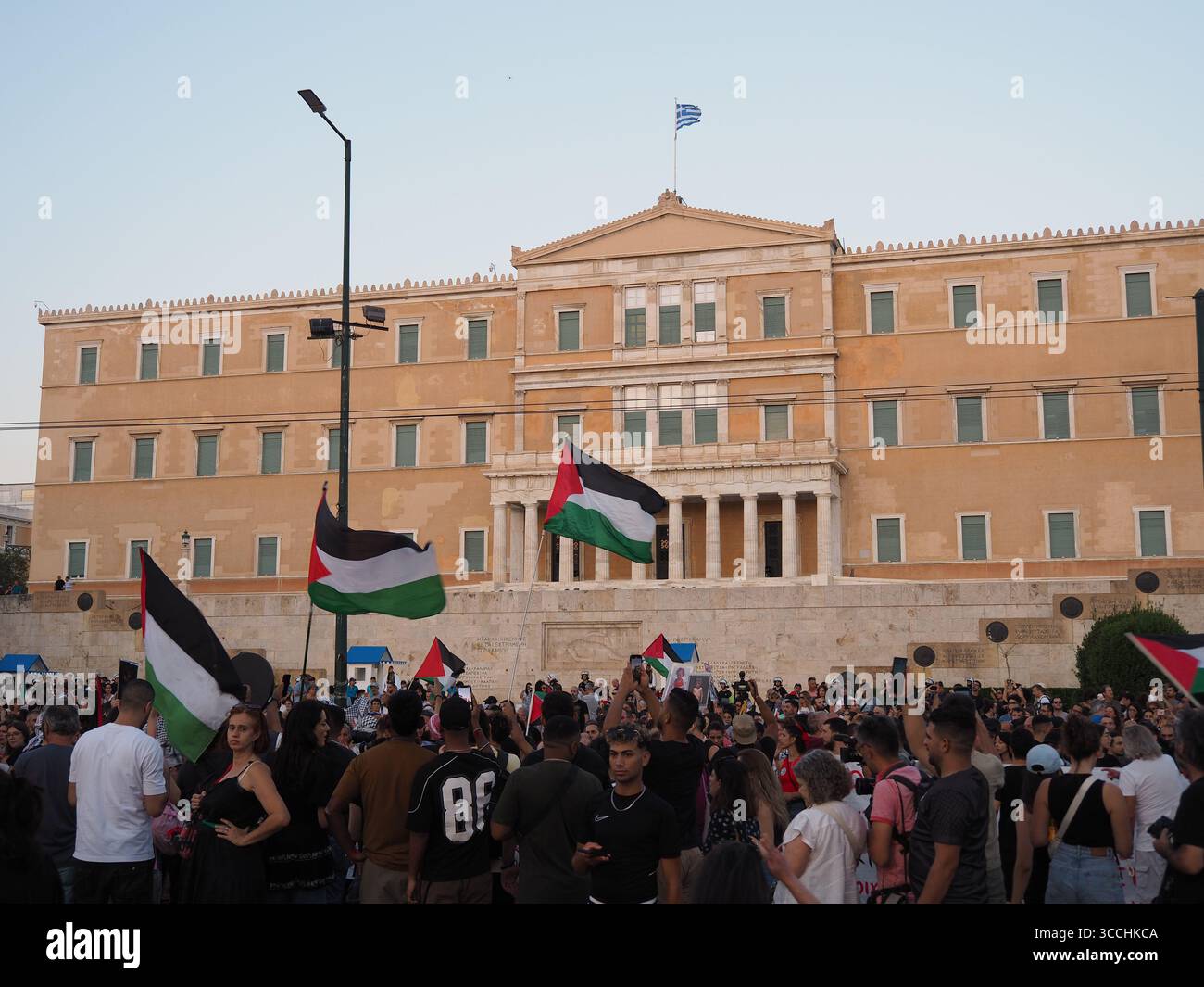Athens, Greece - August 10 2025: Crowd gathers with Palestinian flags ...