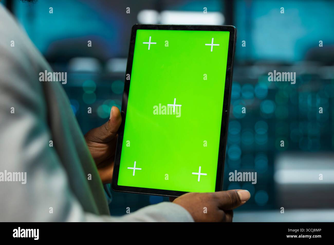 Close up of data center engineer using isolated screen tablet, managing rackmounts energy ...