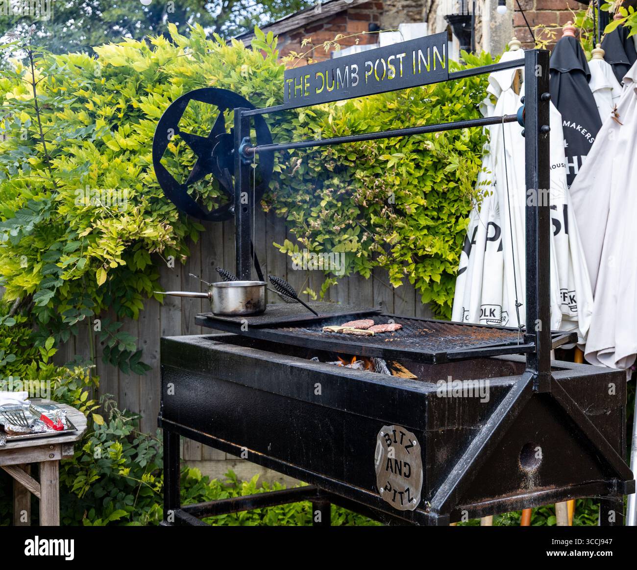 Large outdoor barbecue grill at The Dumb Post Inn garden with cooking ...