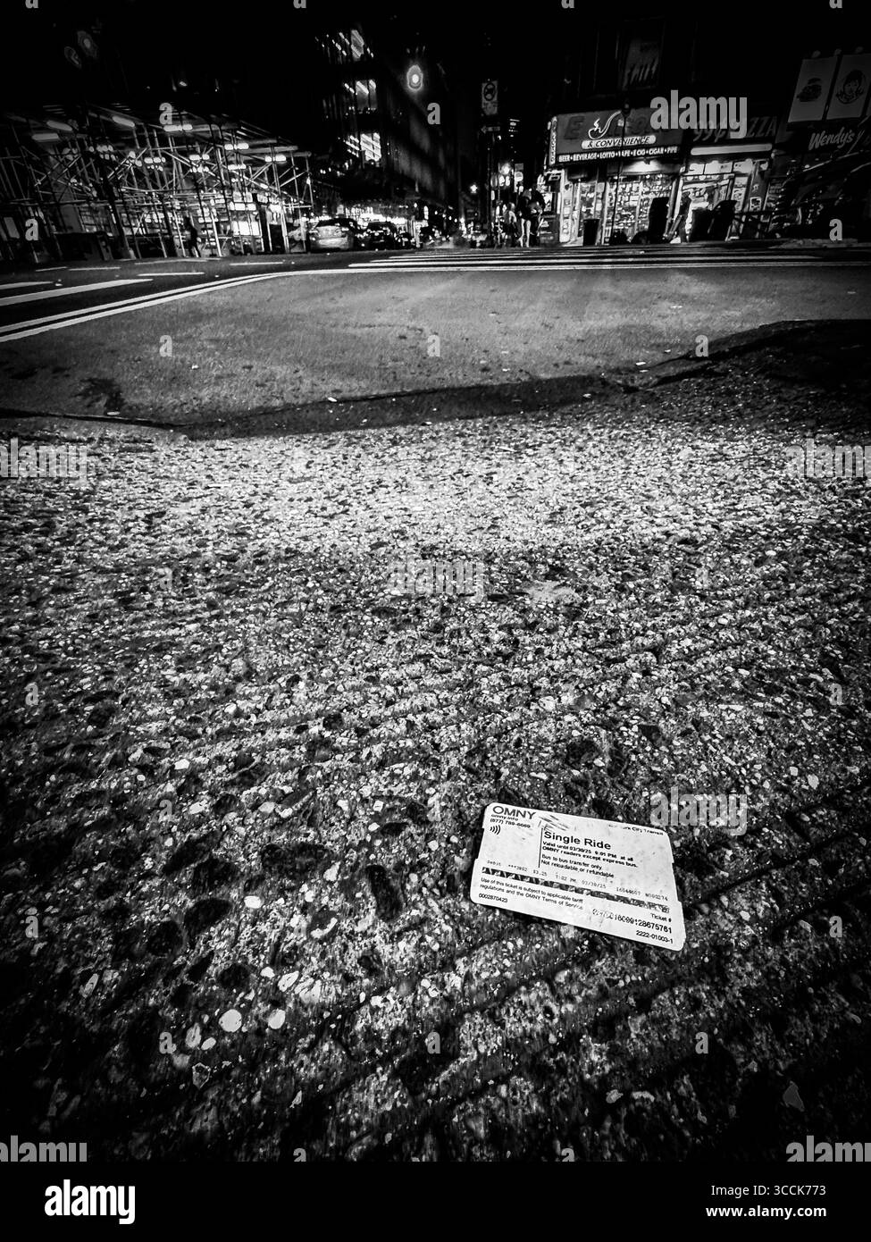 Discarded transit ticket lying on a cobblestone street in Times Square ...
