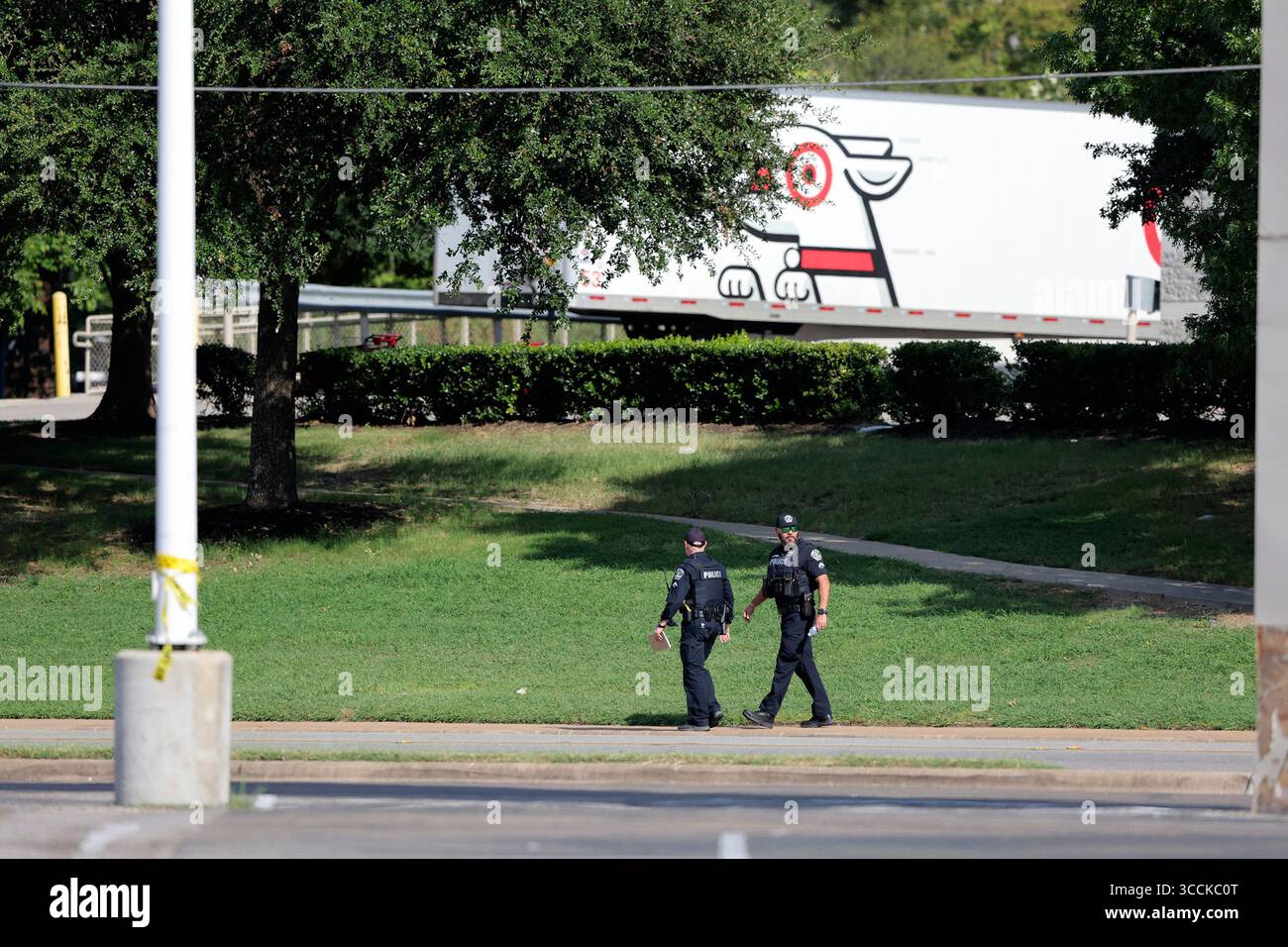 Police monitor the scene near a Target after a shooting in Austin ...