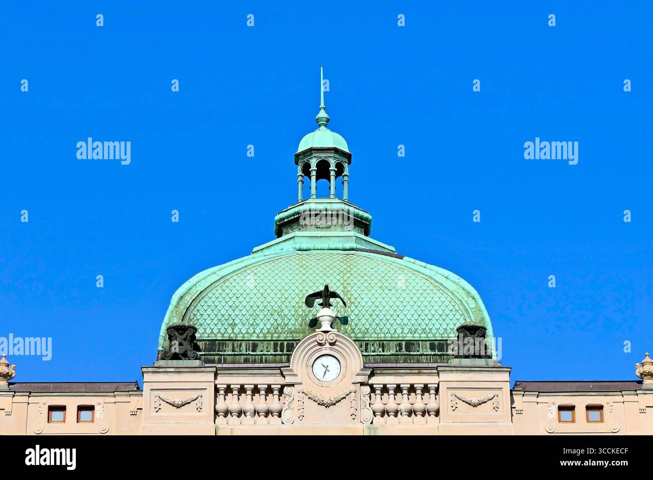 A green copper dome with a rotunda-shaped turret and spire adorns the ...