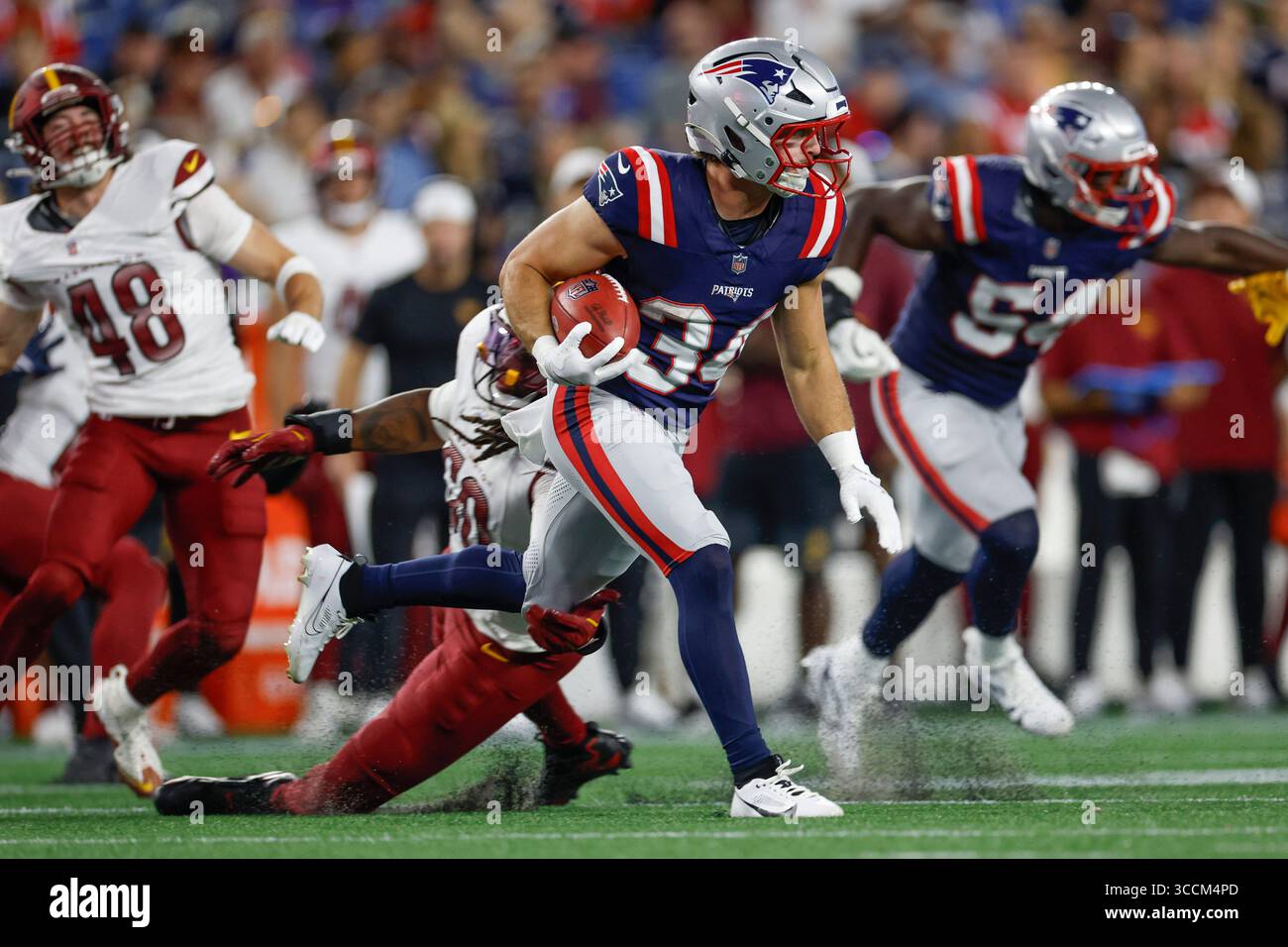 New England Patriots running back Lan Larison (34) escapes the grasp of ...