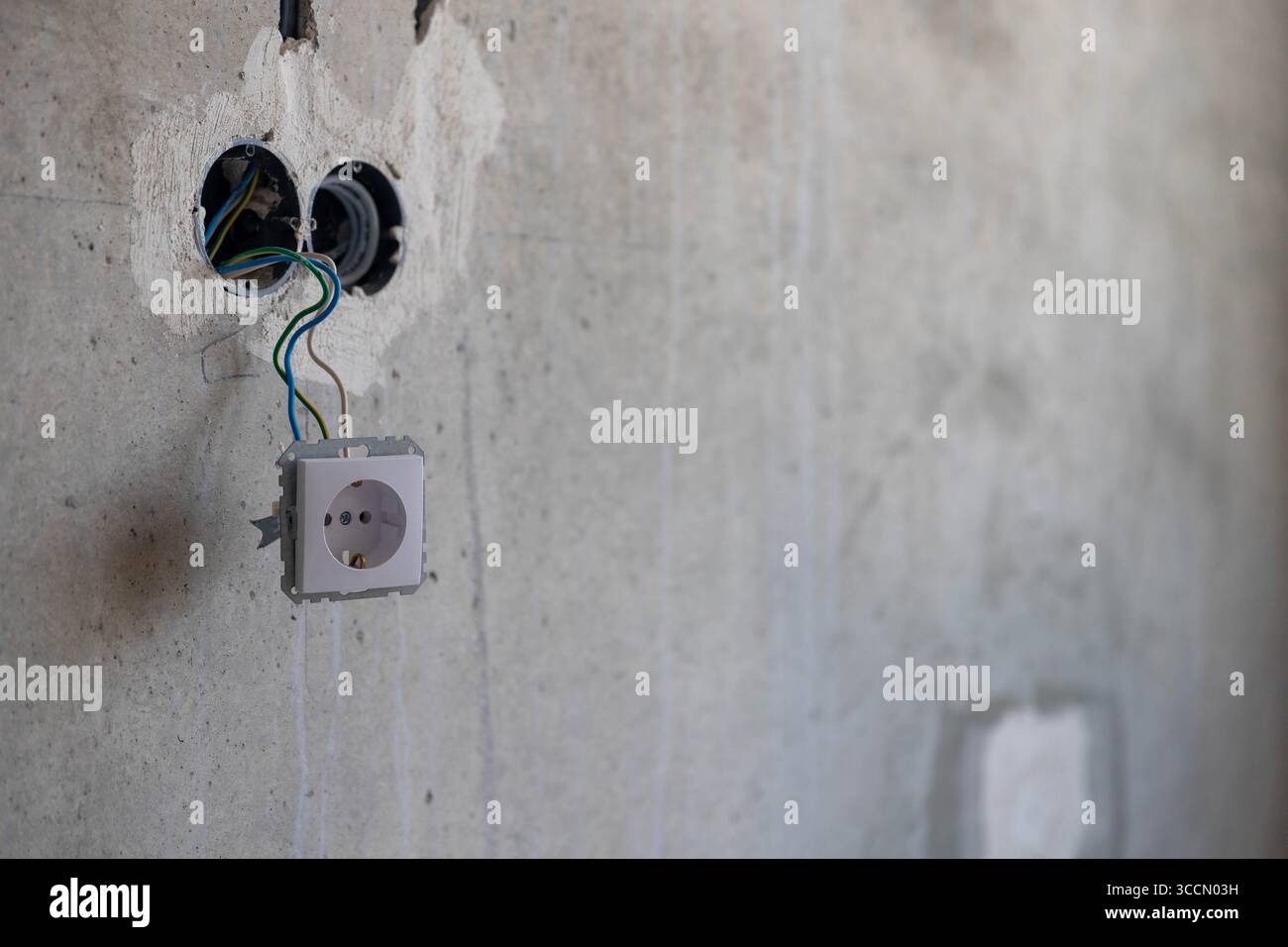 Close-Up of a power plug connected to an electrical socket during ...