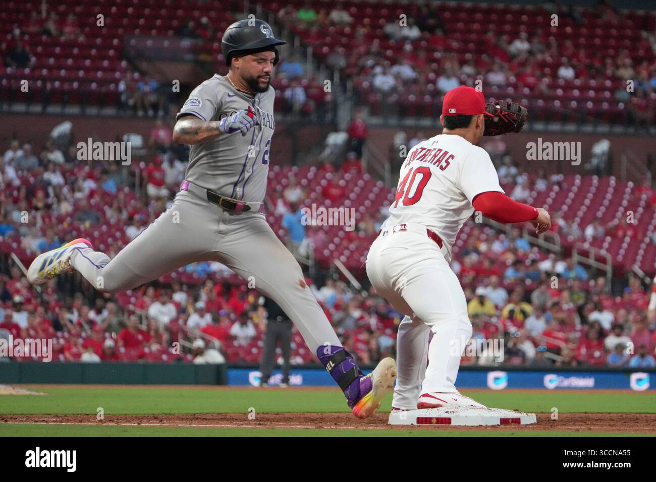 Colorado Rockies' Warming Bernabel, left, grounds out as St. Louis ...