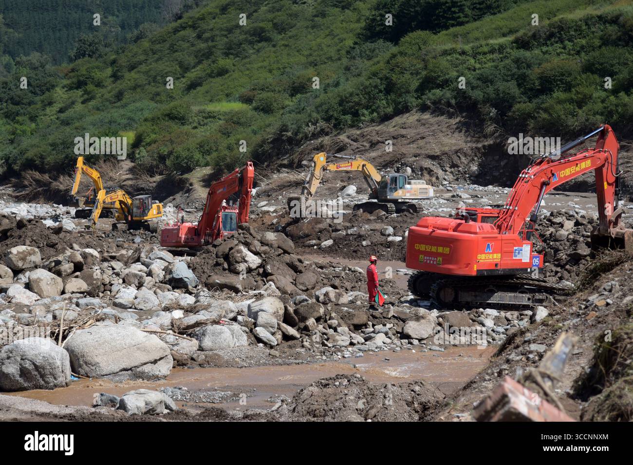 (250812) -- YUZHONG, Aug. 12, 2025 (Xinhua) -- Rescuers clear rocks following flash floods in ...