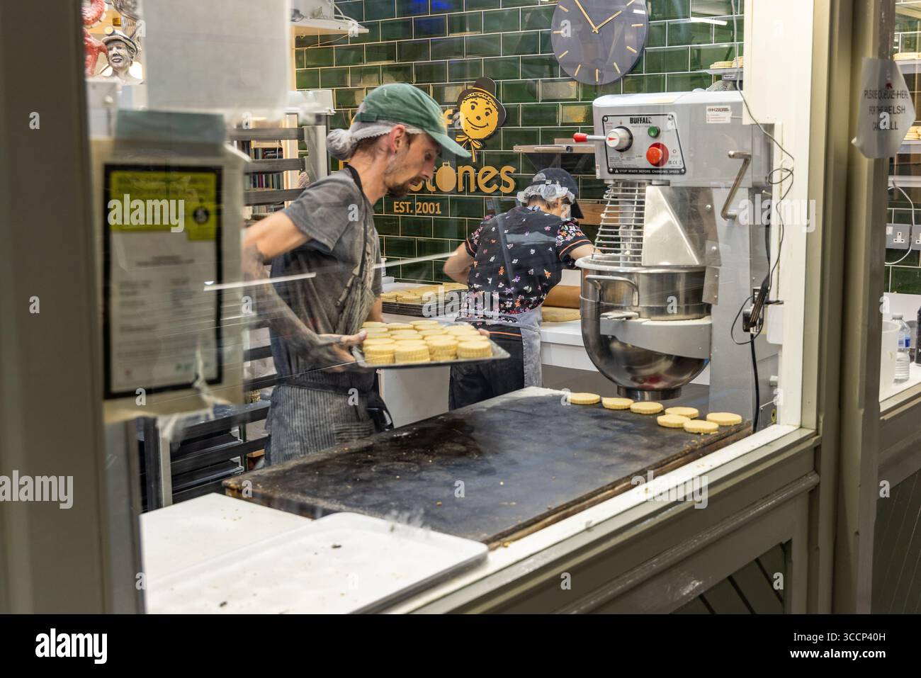 CARDIFF, UK - AUGUST 8, 2025 - Bakers working at a bakery, making ...