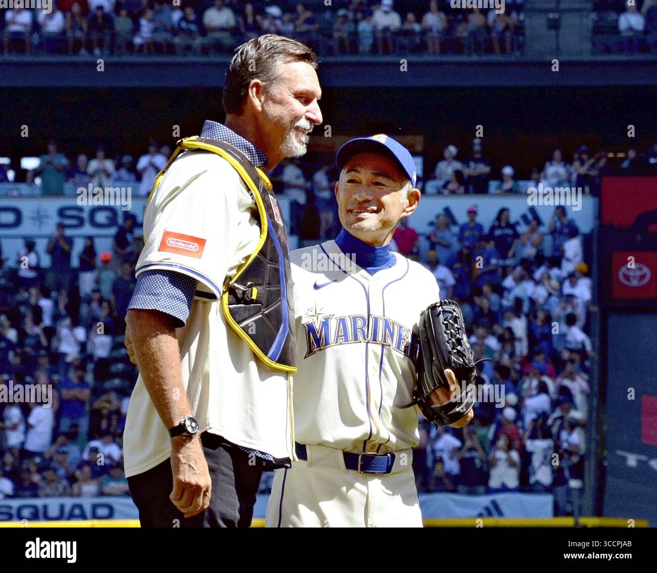 Ichiro Suzuki (R) and Randy Johnson talk after throwing the ceremonial ...