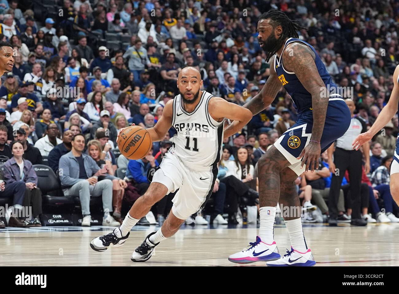 San Antonio Spurs guard Jordan McLaughlin (11) drives past Denver ...