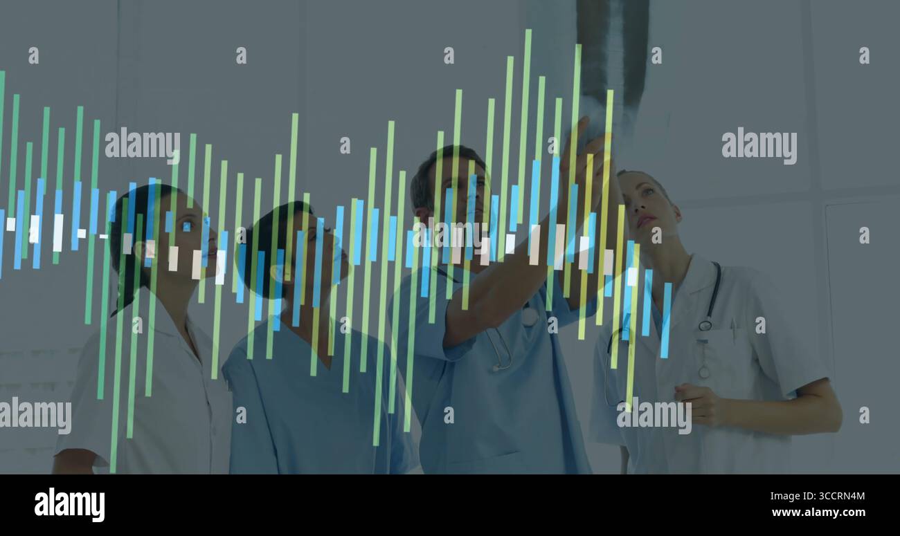 Analyzing nurses in scrubs and doctors reviewing scan display in ...