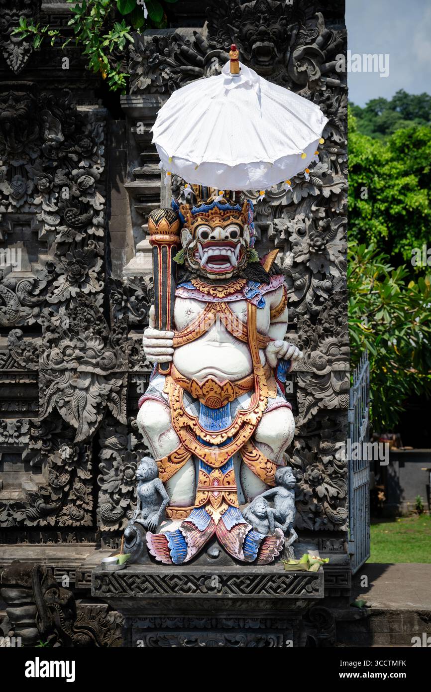 Dvarapala guardian statue with small monkey figures at its base ...