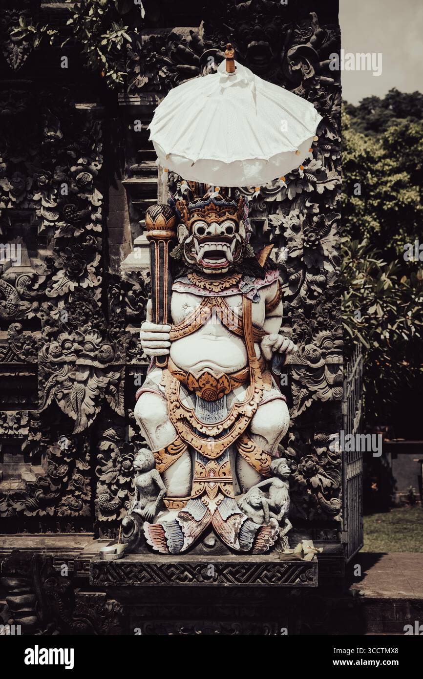 Dvarapala guardian statue with small monkey figures at its base ...