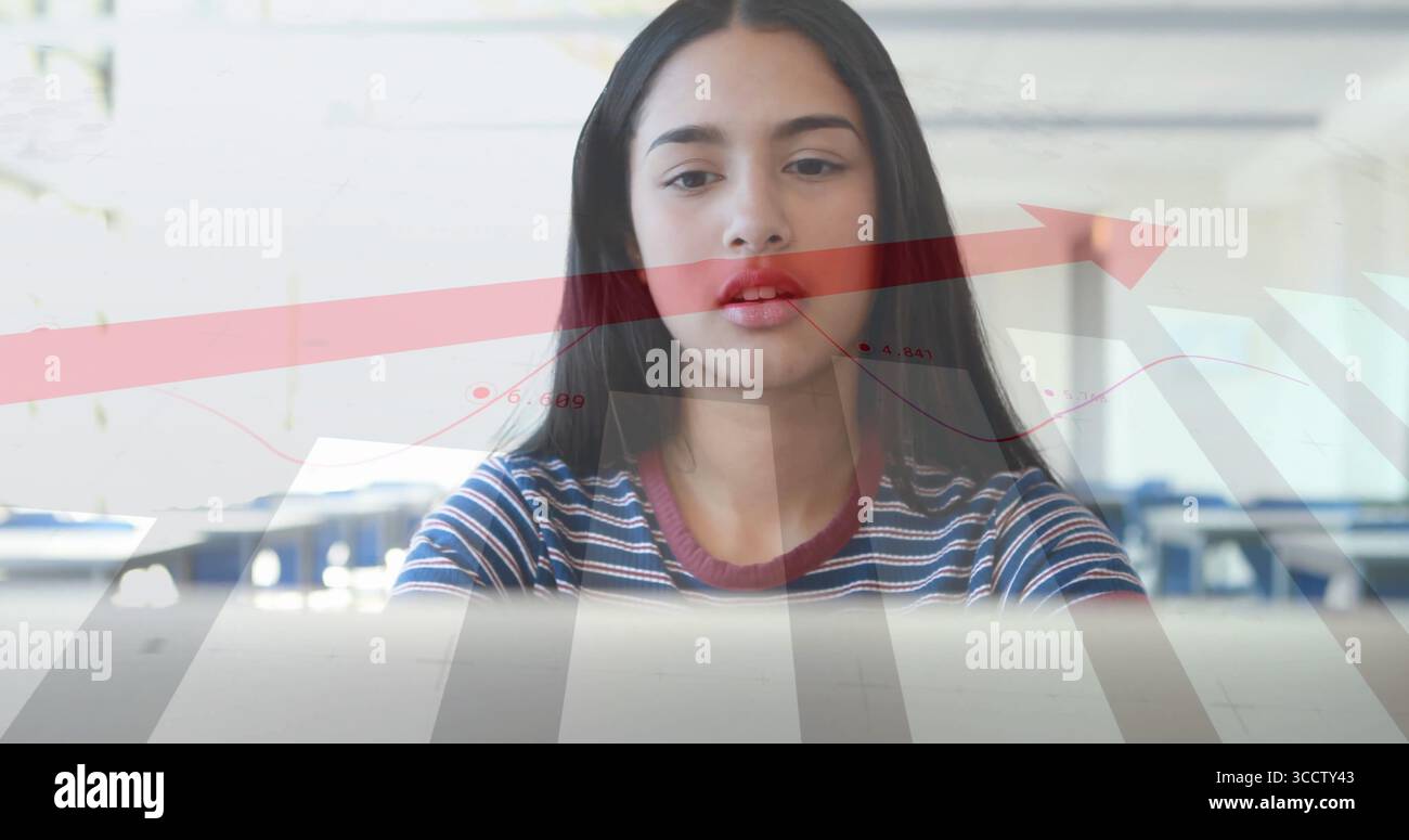 Analyzing student interpreting data on open laptop at computer lab, red arrow graph and bar ...