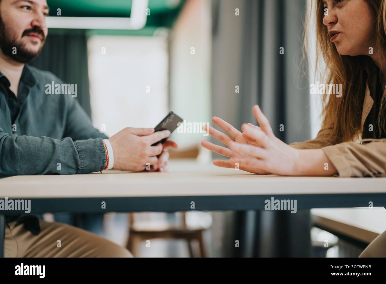 Two people discussing in a relaxed cafe environment during a ...