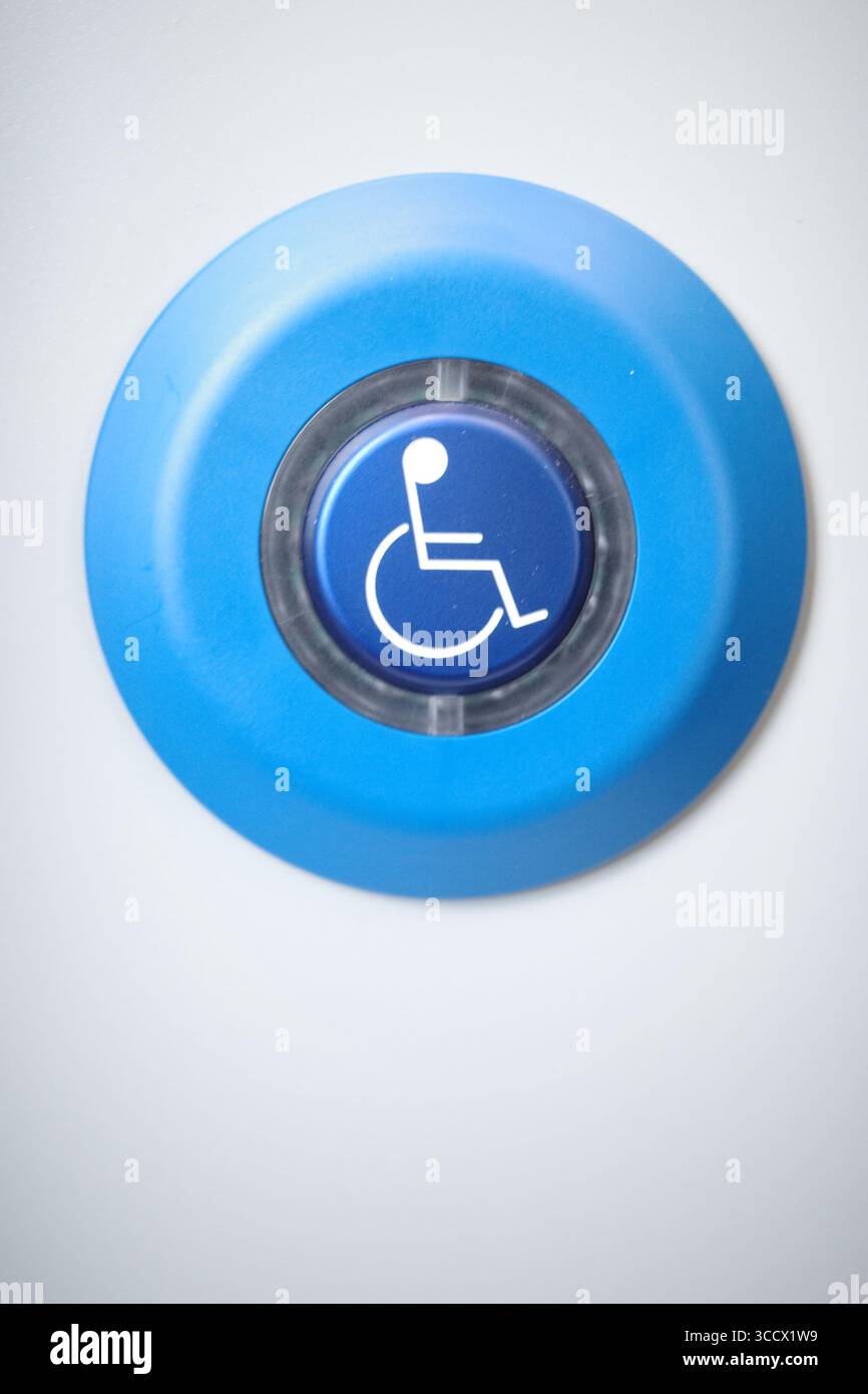 Blue button with a wheelchair symbol on it Stock Photo - Alamy