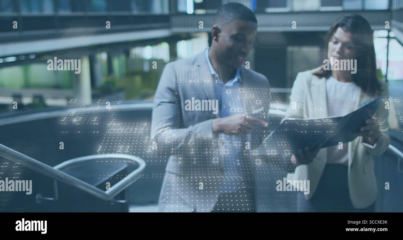 Studying colleagues in suits pointing and scanning files in office ...